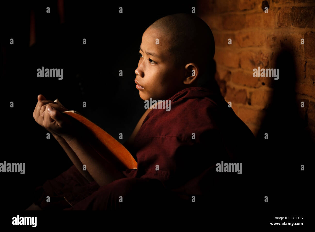 Young novice monk learning inside monastery Stock Photo - Alamy