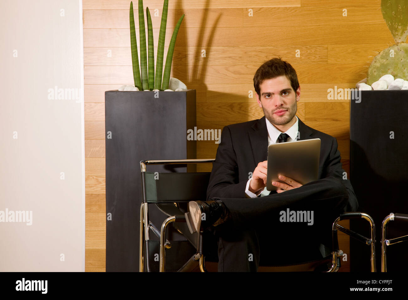 business man waiting in office lobby Stock Photo - Alamy