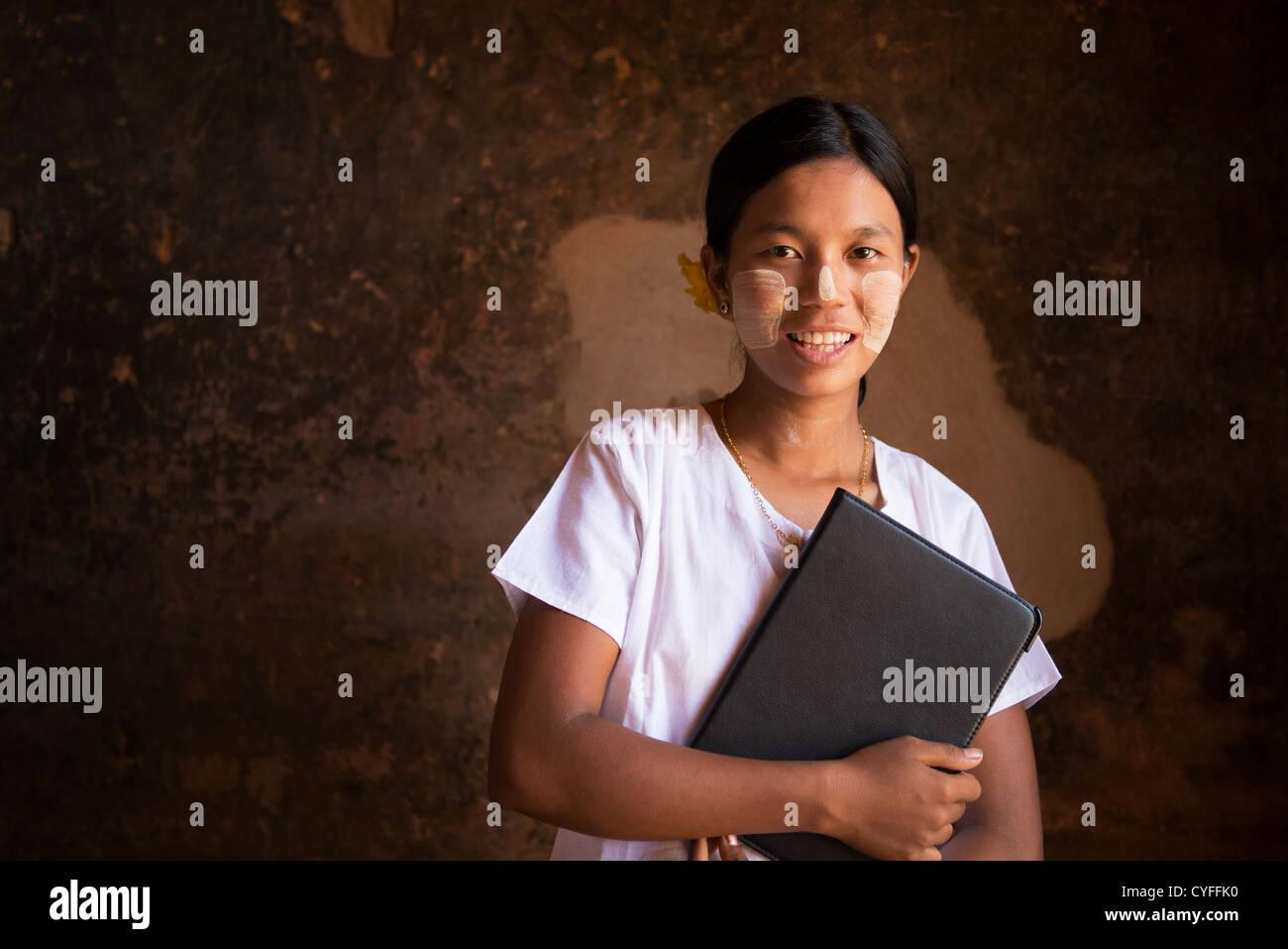 Traditional Myanmar student holdong a file folder Stock Photo - Alamy