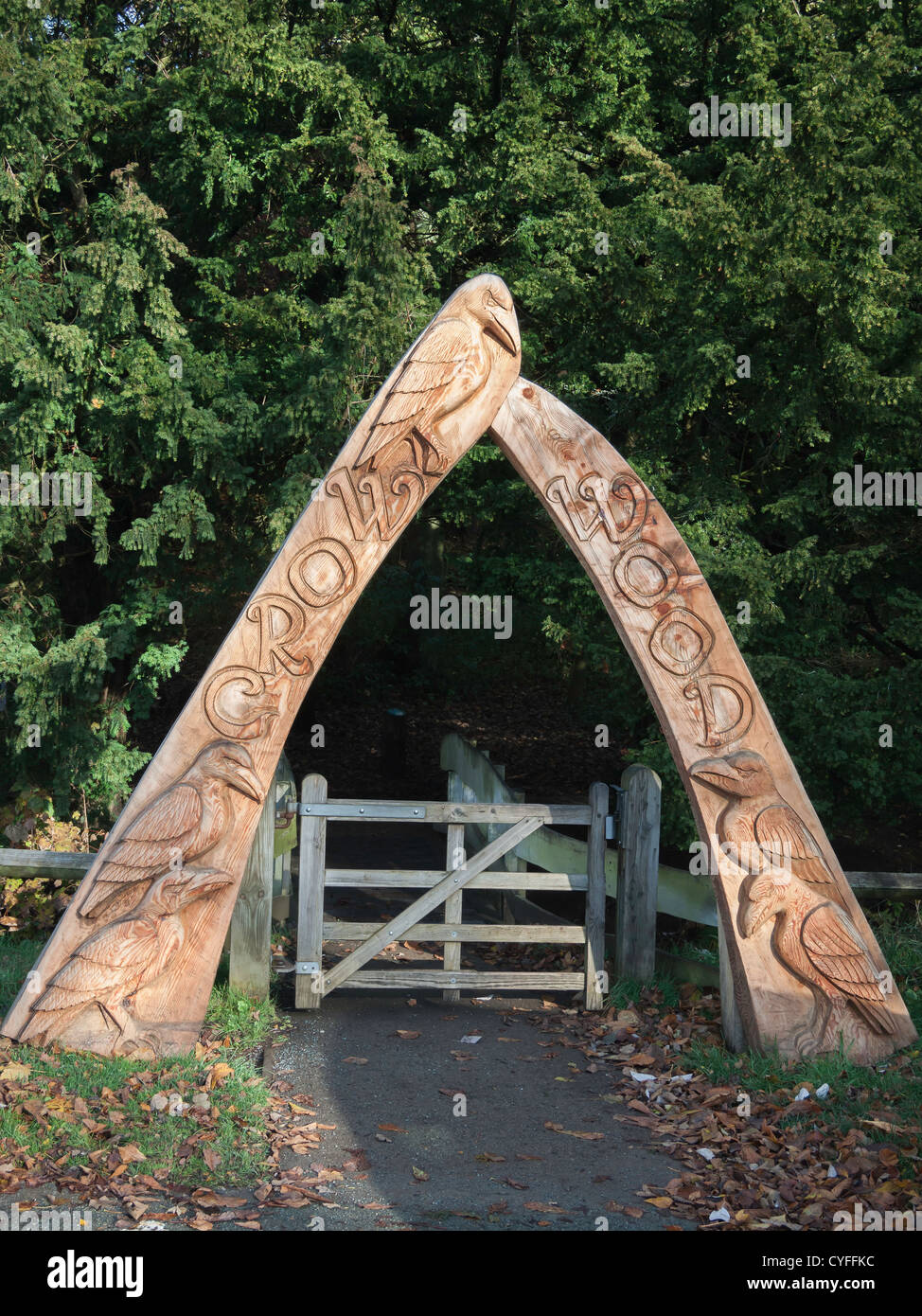 Carved wooden arch at the entrance to Crow Wood an area of woodland for ...