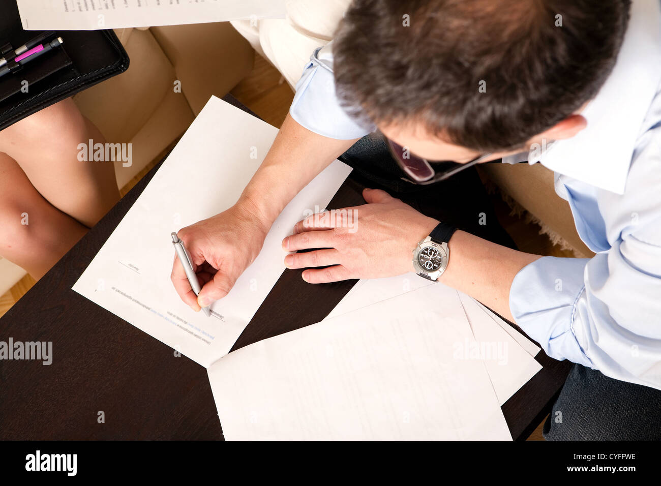Man signing an agreement. Just sign here Stock Photo - Alamy