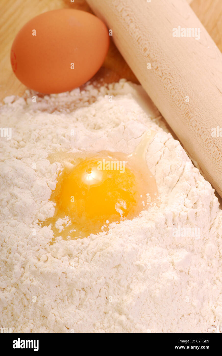 Mixing eggs and flour using the well method for pasta Stock Photo - Alamy