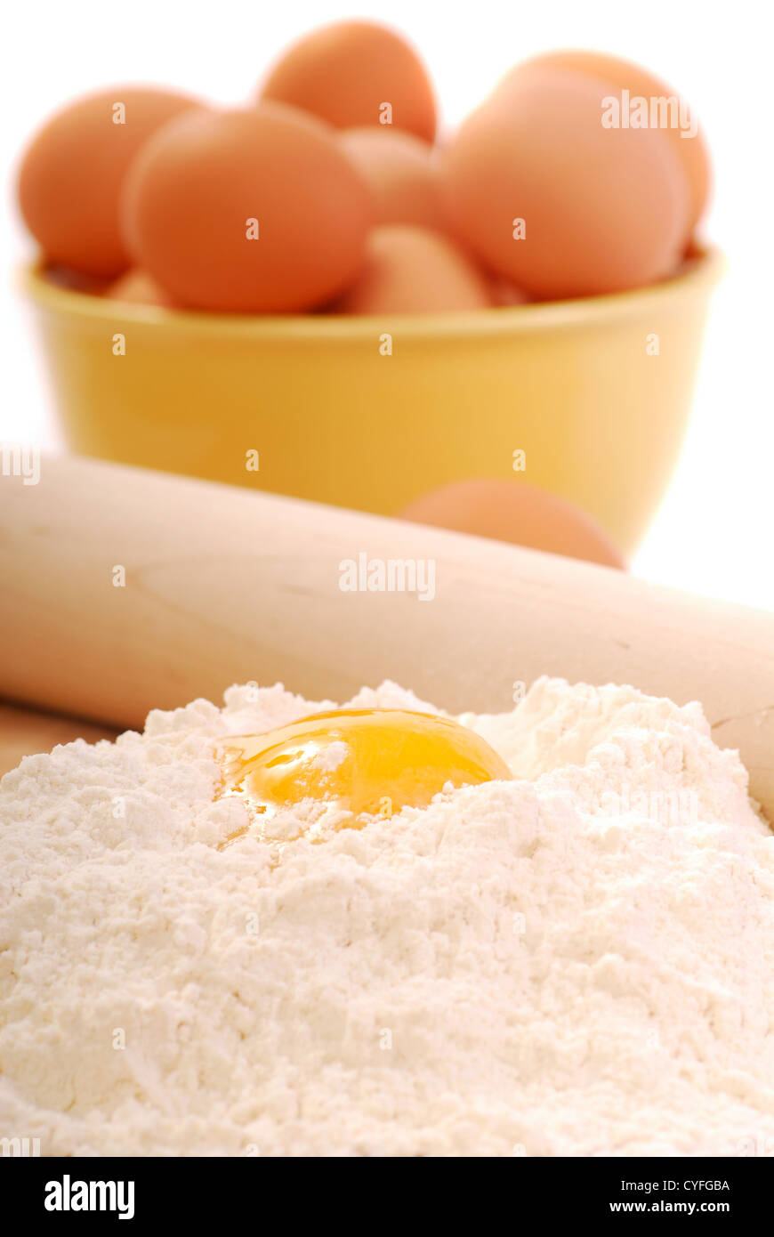 Mixing eggs and flour using the well method for making pasta Stock ...