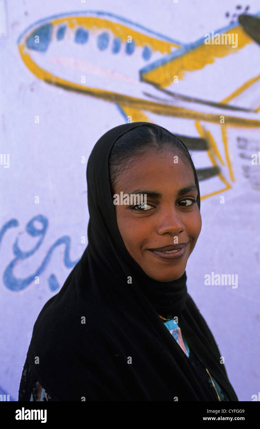 Egypt. Aswan. Woman of Nubian tribe in traditional dress in front of ...