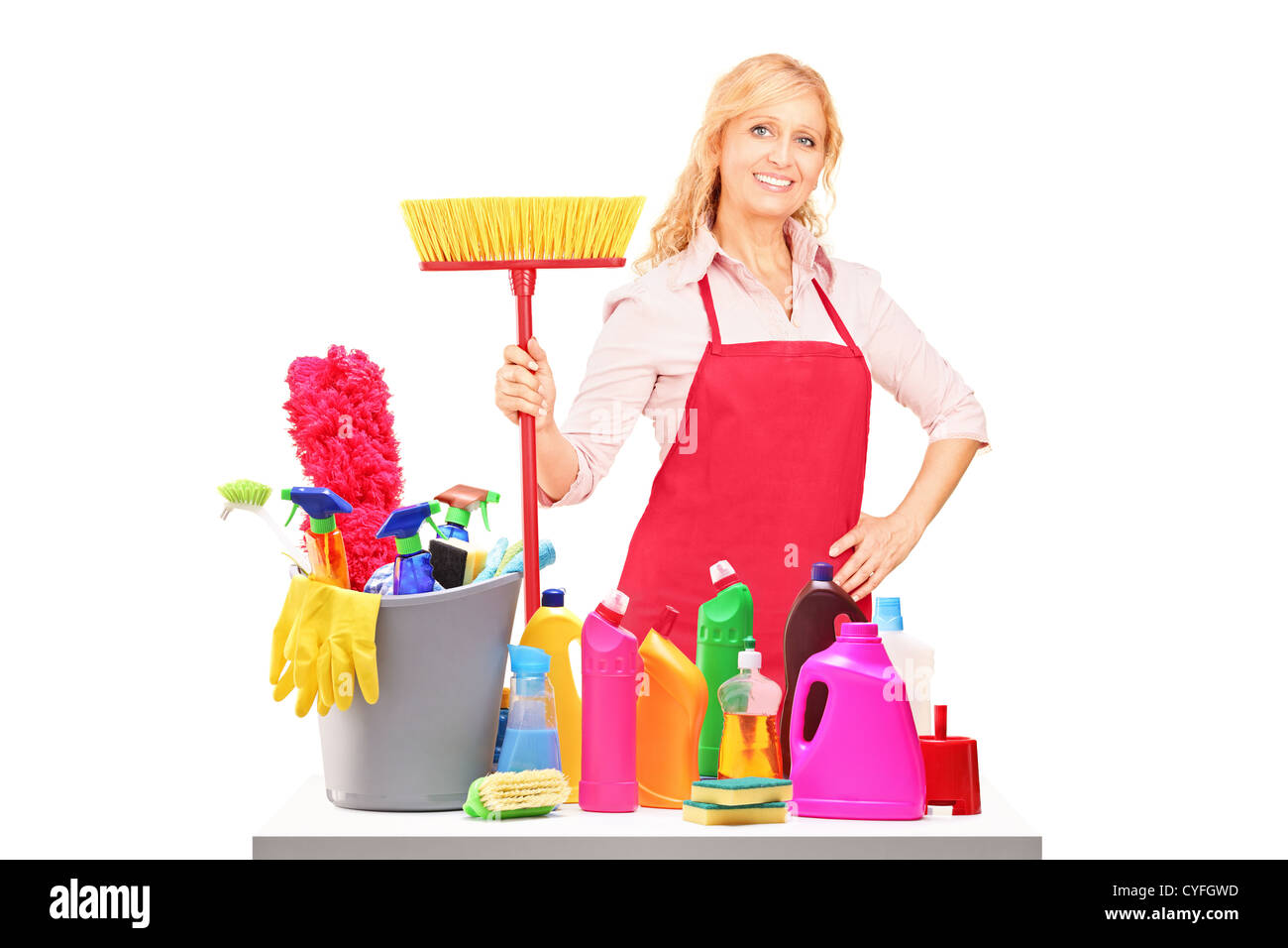 A female cleaner posing with cleaning equipment isolated against white ...