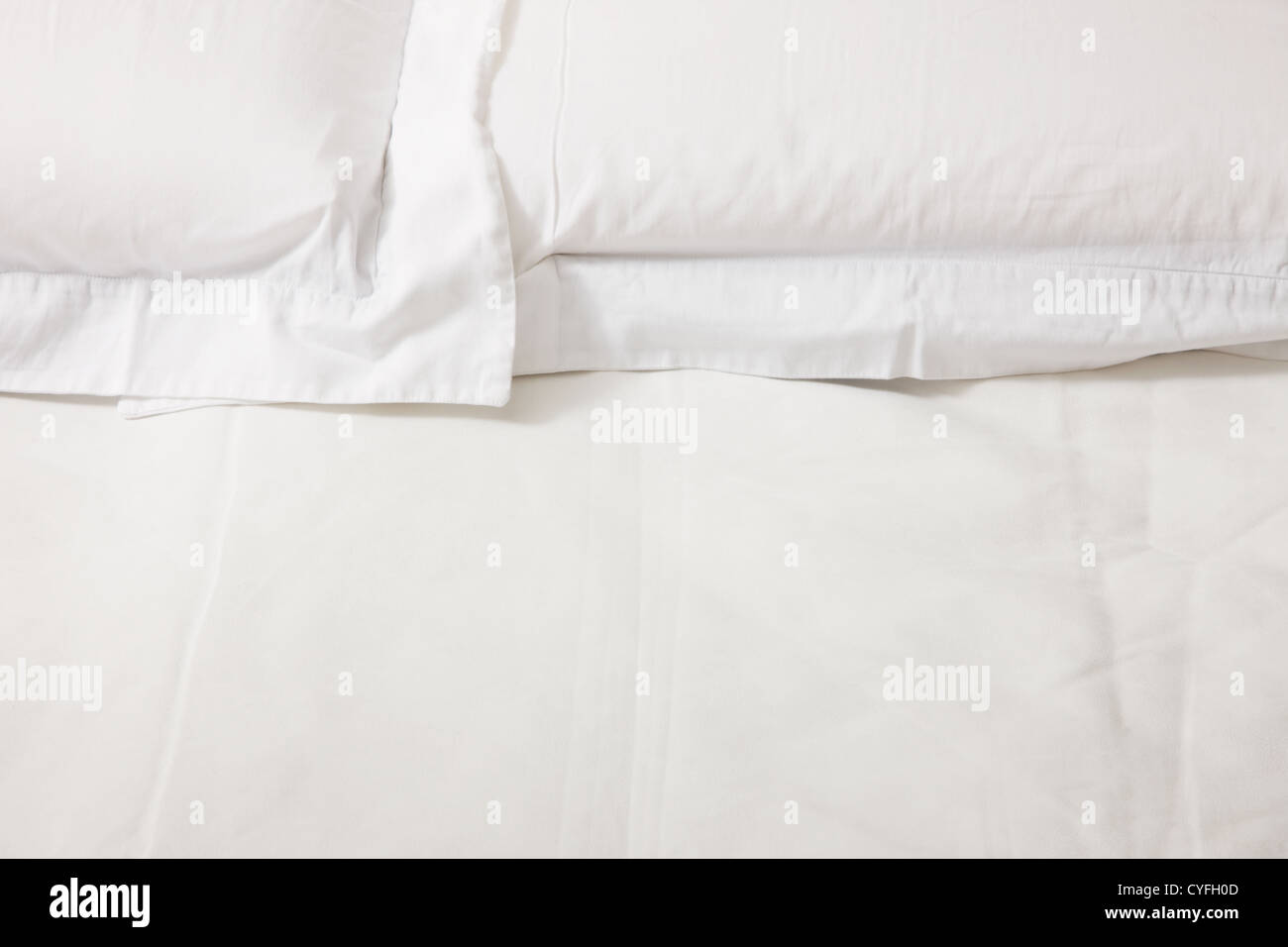 double bed with white linens Stock Photo - Alamy