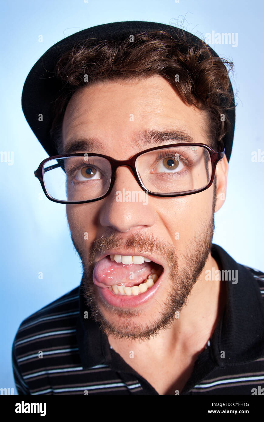 Young man modern nerd with hat and glasses wide angle close up portrait ...