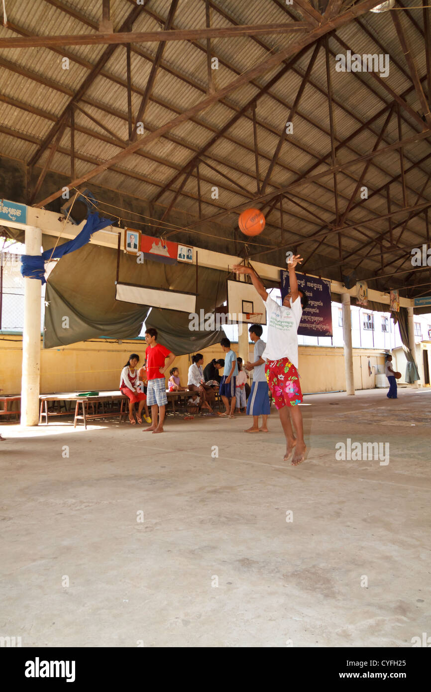 School children playing basketball in sports hall hi-res stock ...