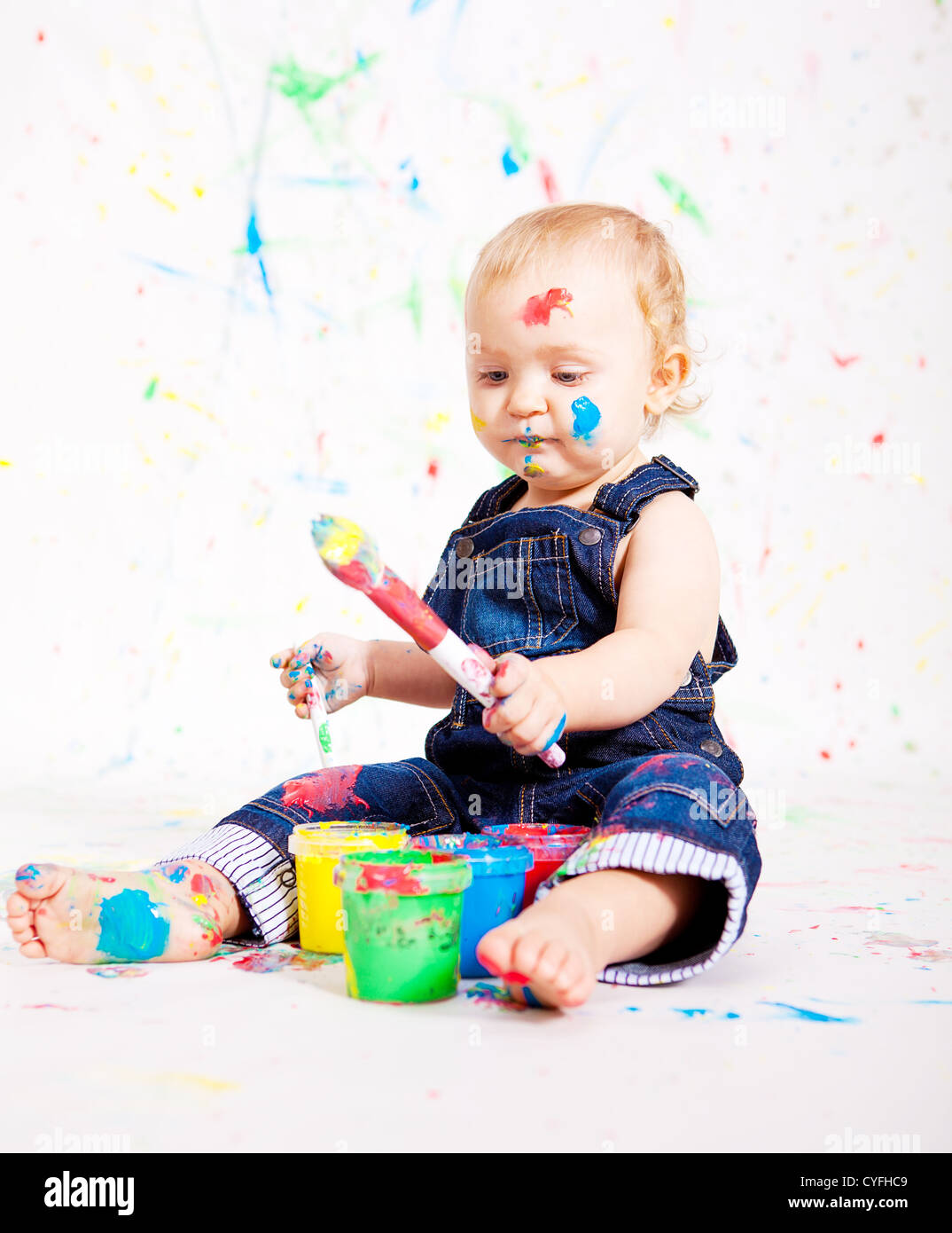 cute little baby painting and splatter with colours creativity on white ...