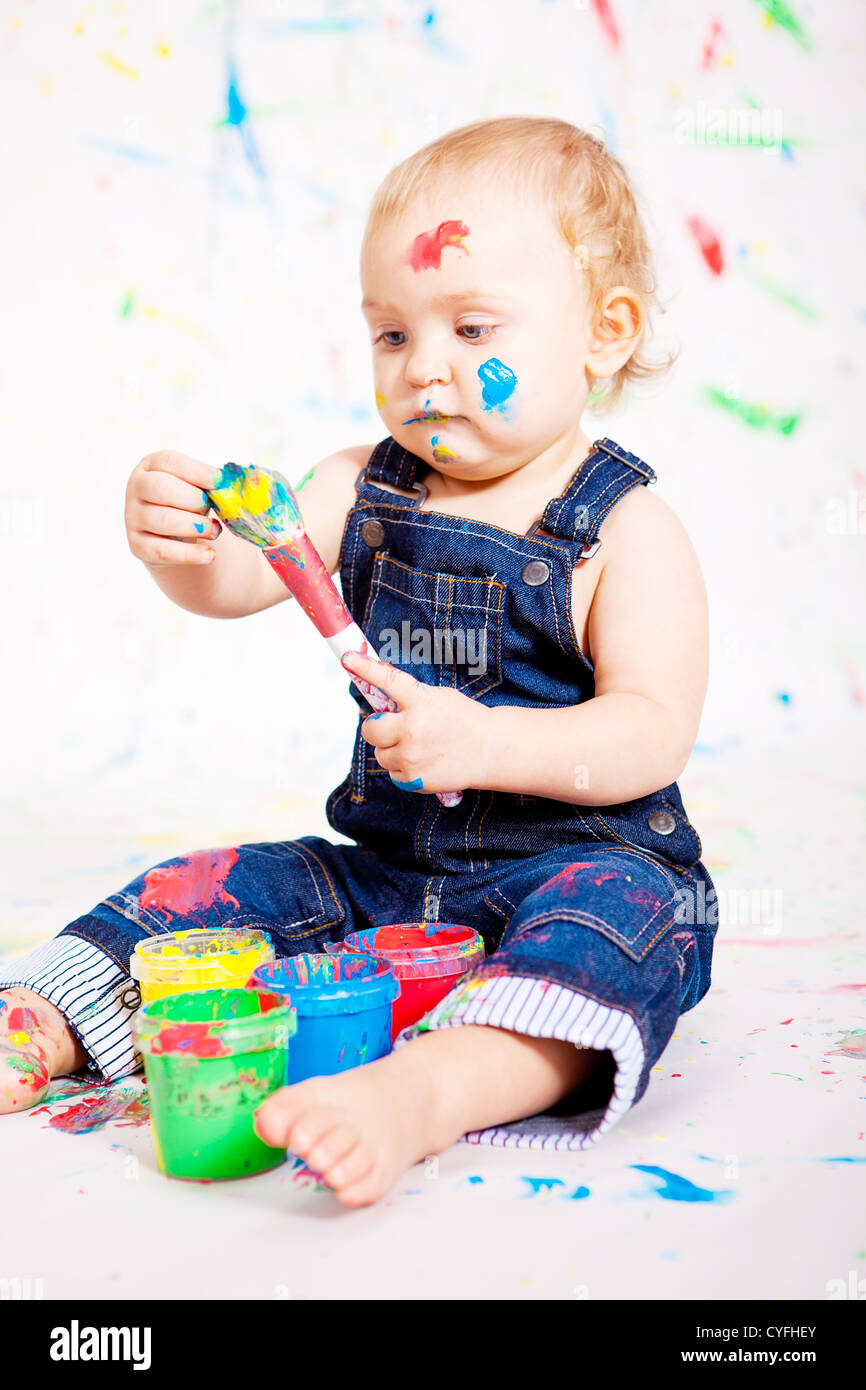 cute little baby painting and splatter with colours creativity on white ...