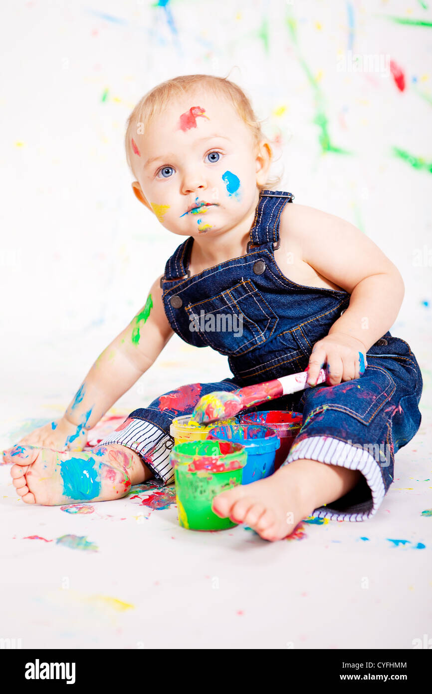 cute little baby painting and splatter with colours creativity on white ...