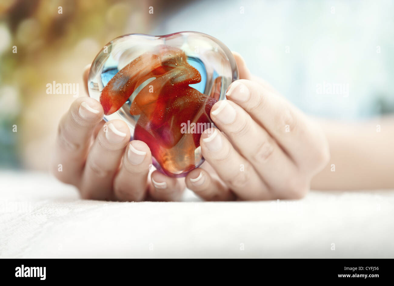 Woman hands holding heart shape object Stock Photo - Alamy