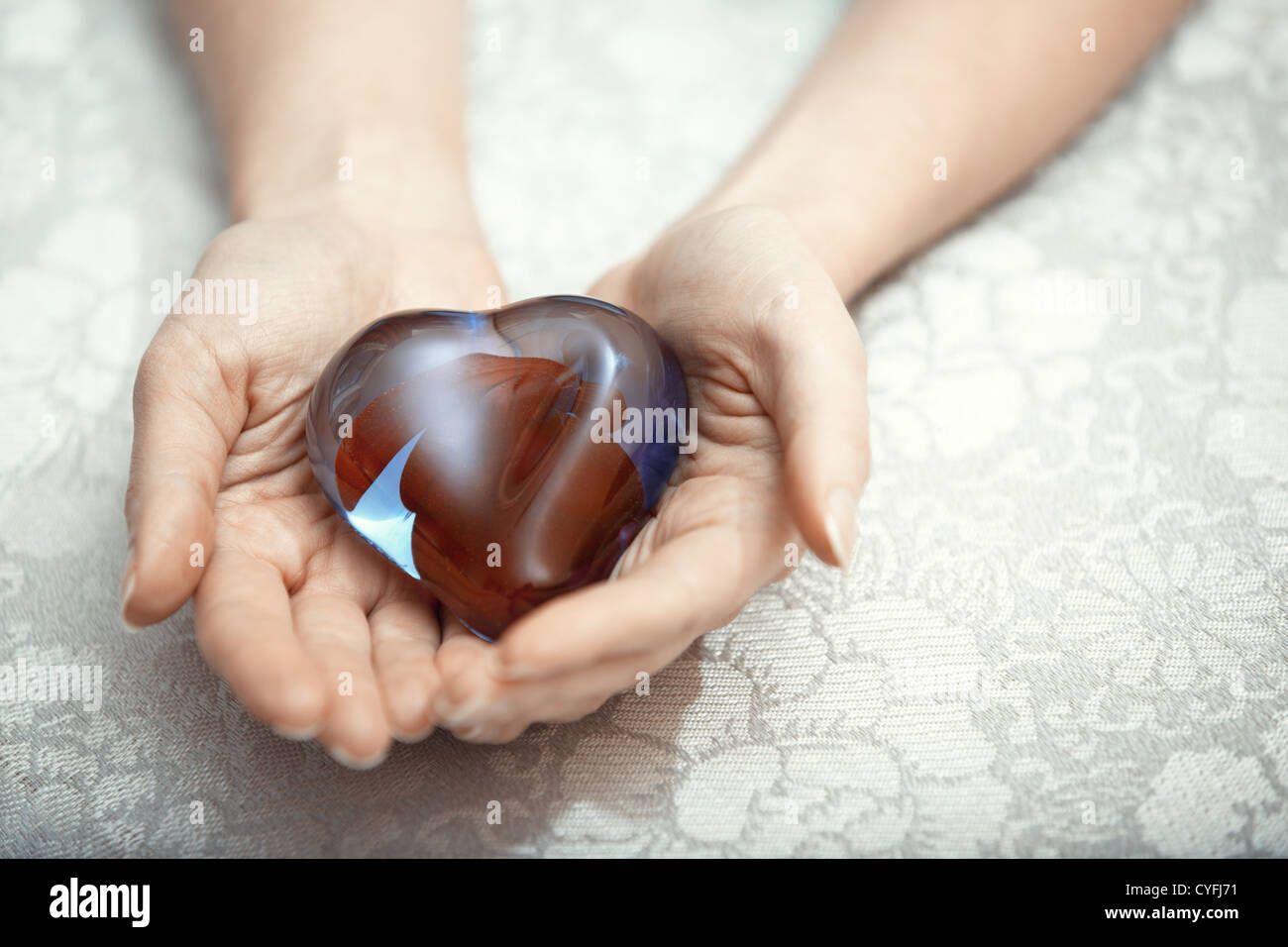 Woman hands holding heart shape object Stock Photo - Alamy