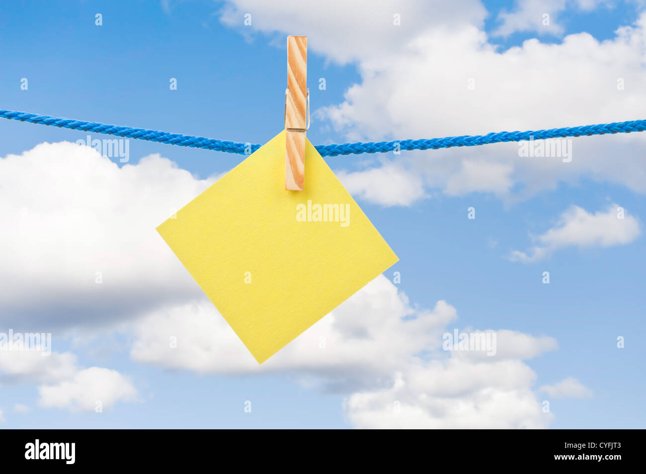 Yellow note hanging in a rope with sky background Stock Photo - Alamy
