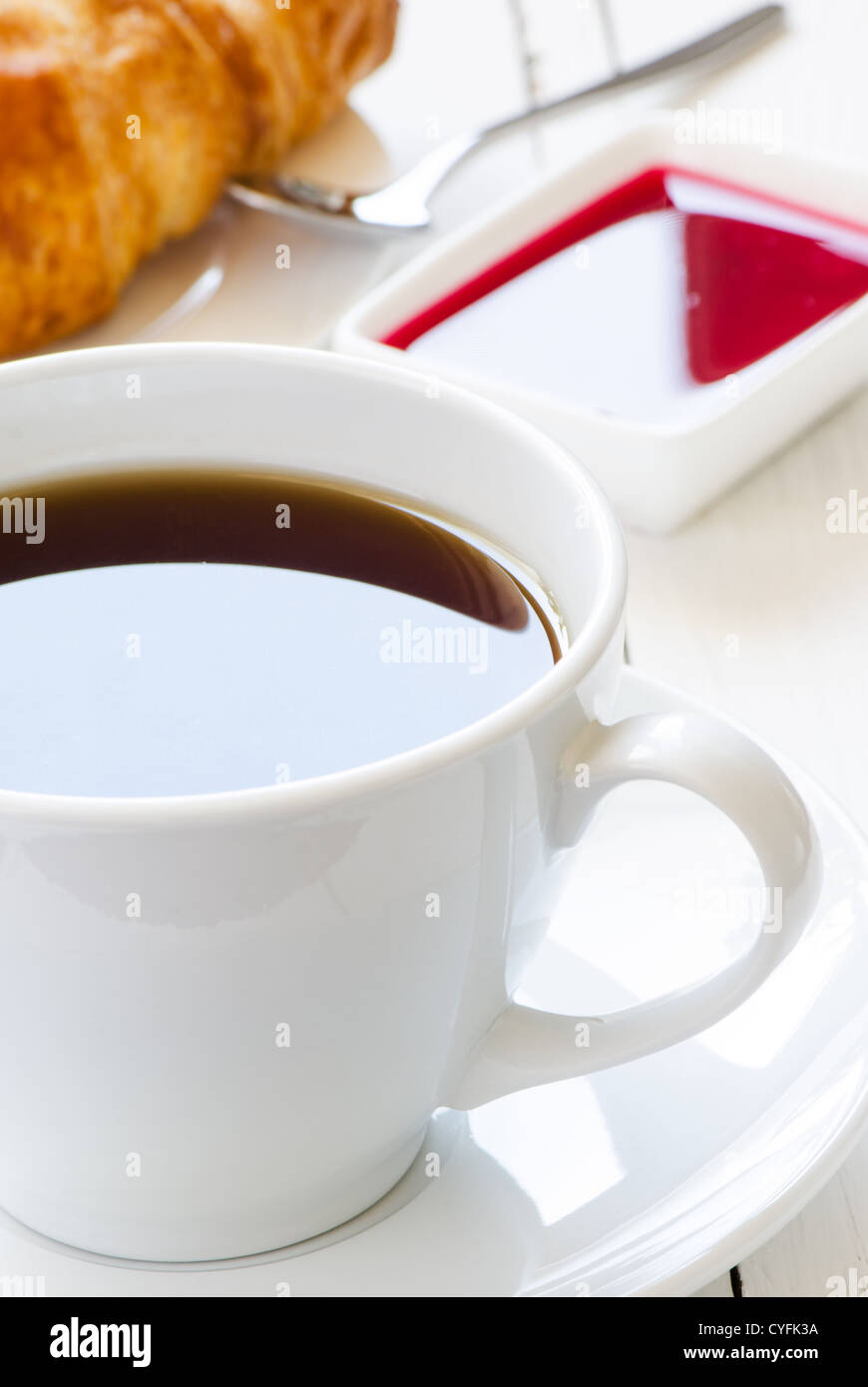 Cup of black coffee with jem and croissant on background Stock Photo ...