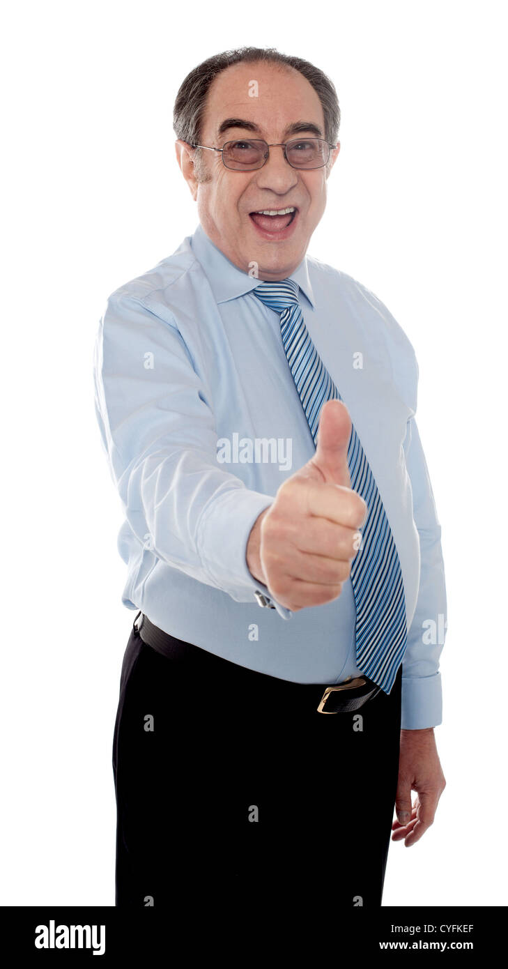 Handsome senior manager gesturing thumbs-up at you against white ...