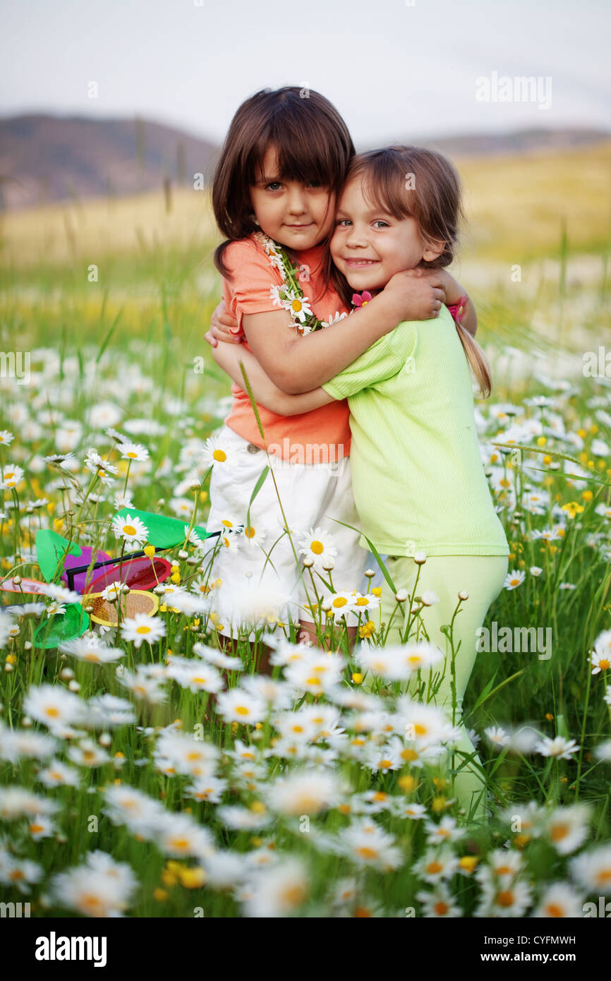 Portrait of little friends hugging Stock Photo - Alamy