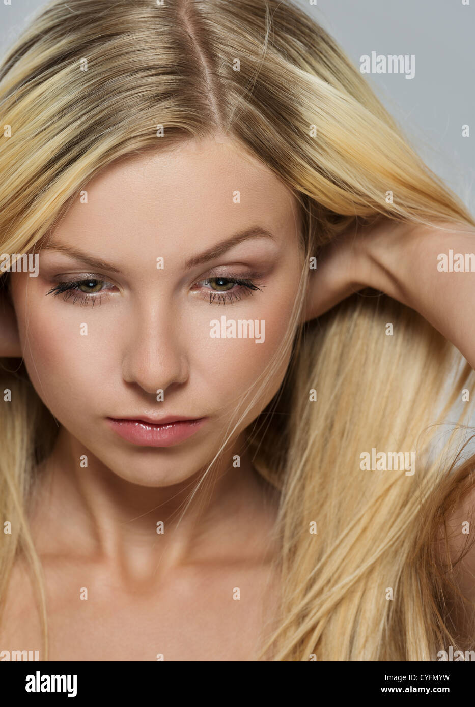 Portrait of blond girl tweaking hair Stock Photo - Alamy