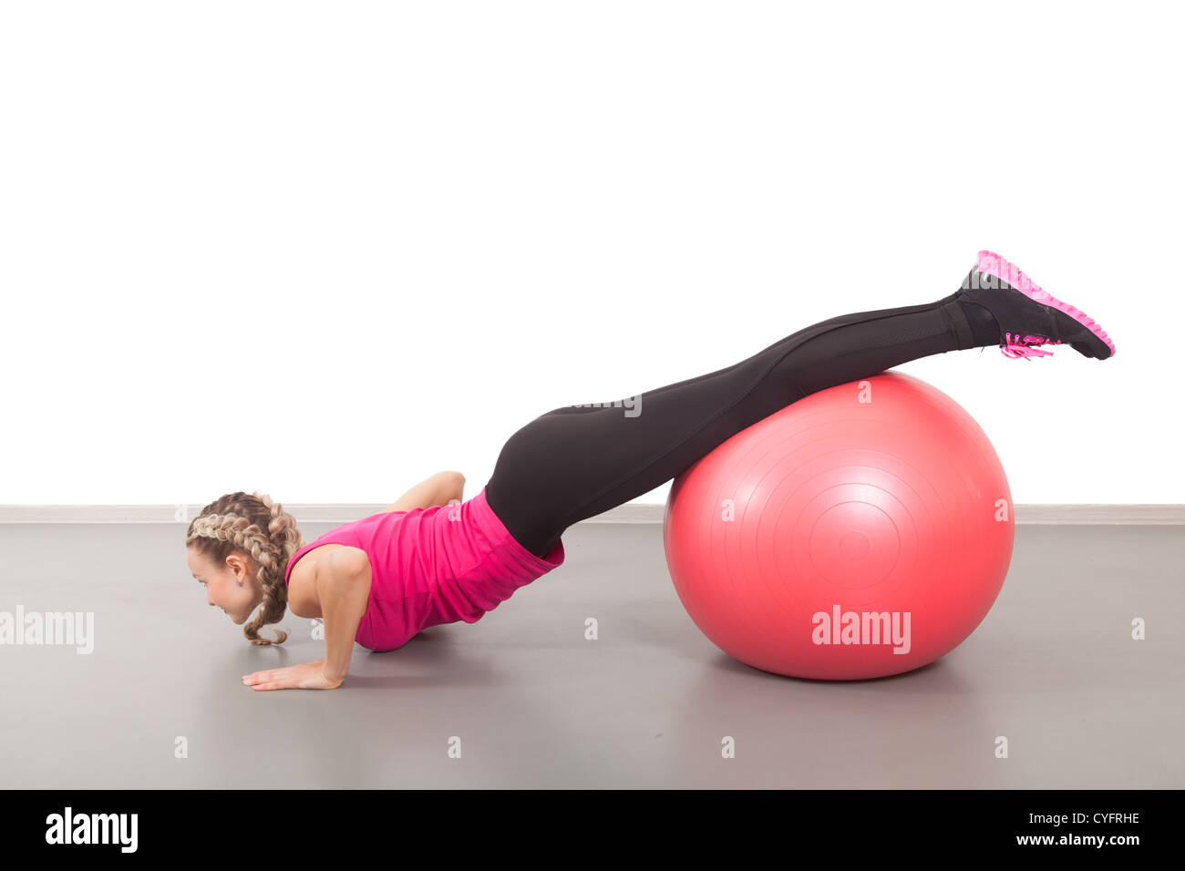 Athletic young woman with red ball on the floor Stock Photo - Alamy