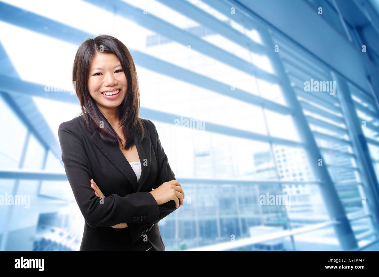 Young Executive standing in office building Stock Photo - Alamy
