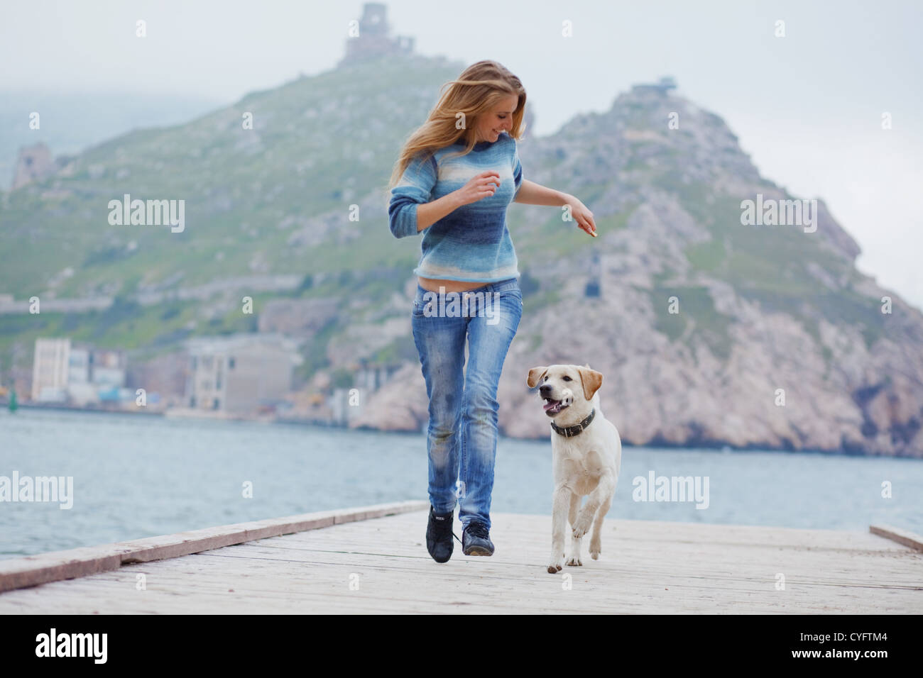Girl with dog running Stock Photo - Alamy