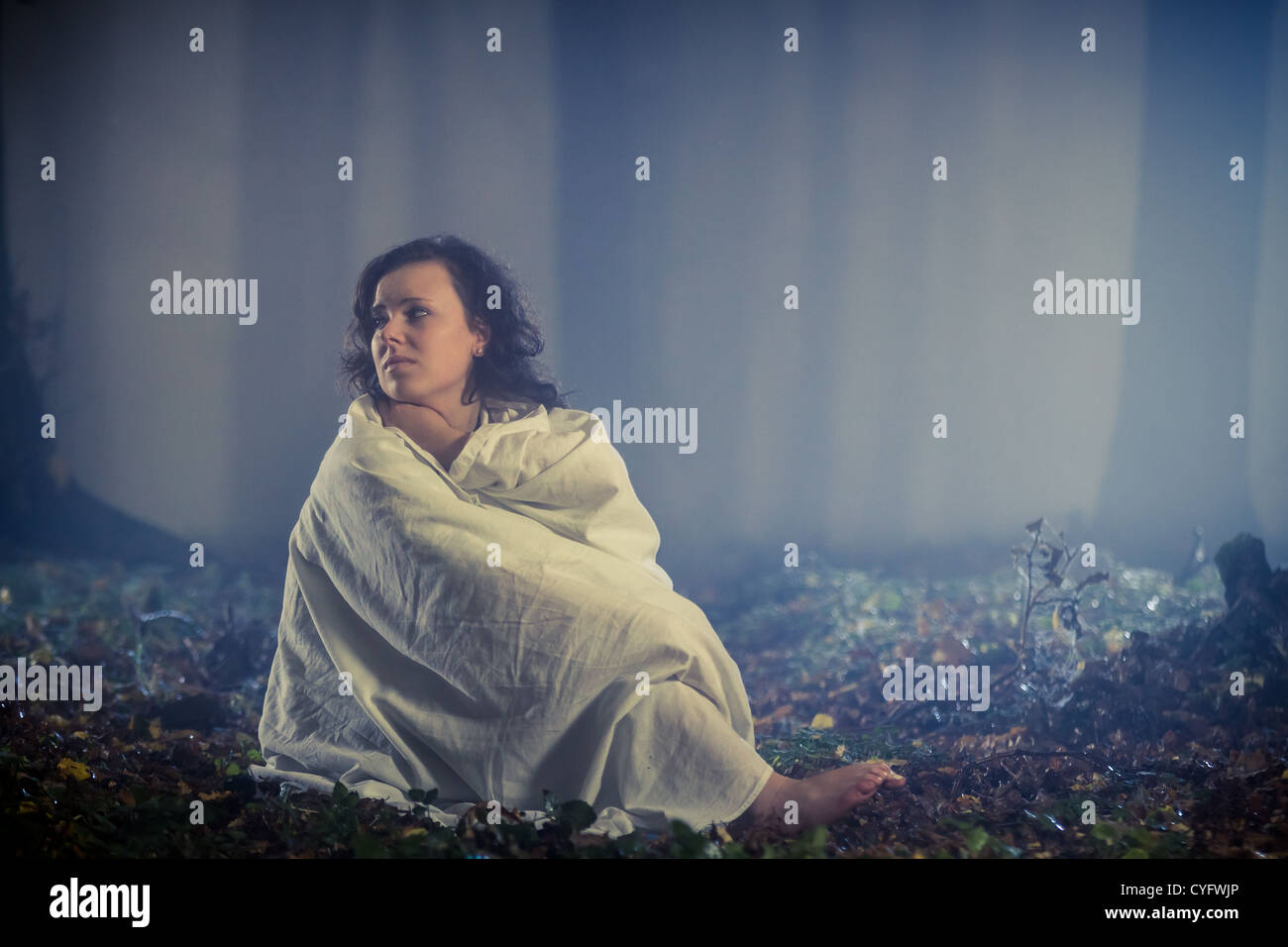 Scared woman in dark forest Stock Photo - Alamy