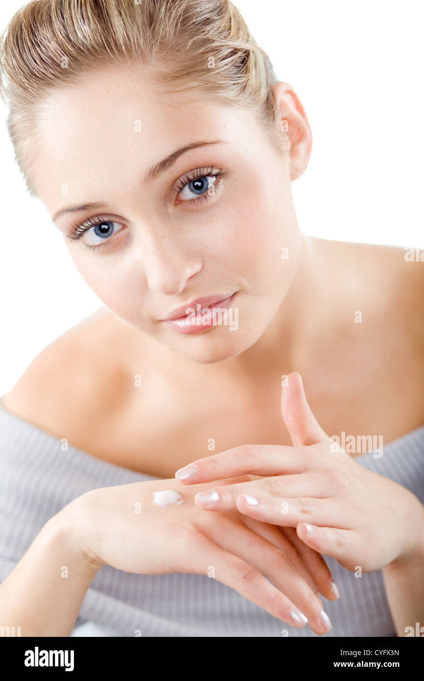 Young beautiful woman applying hands cream and looking at camera Stock ...