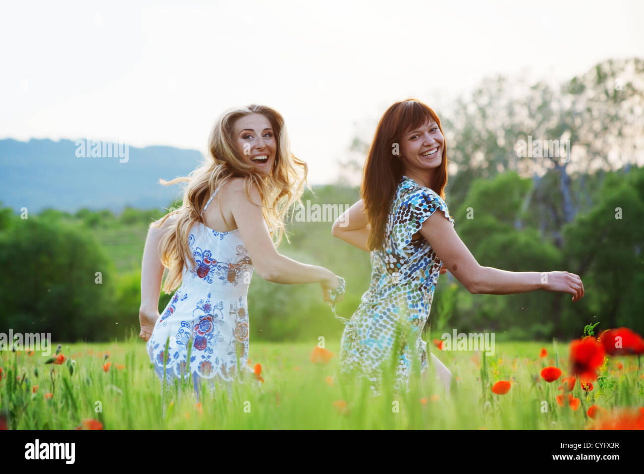 Girls in spring field Stock Photo - Alamy
