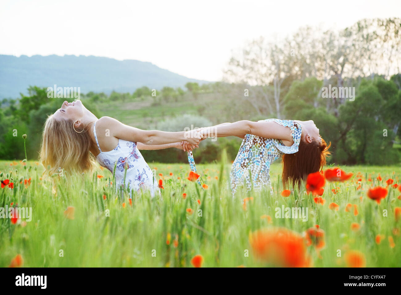 Girls in spring field Stock Photo - Alamy