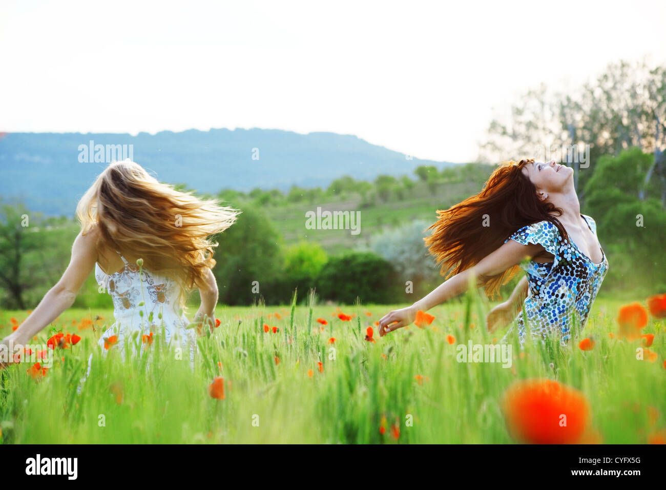 Girls in spring field Stock Photo - Alamy