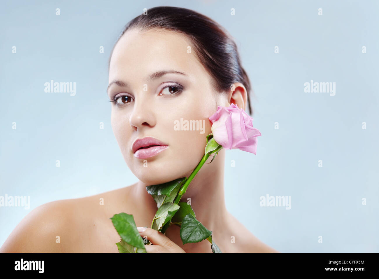 Studio portrait of sensual beautiful woman with rose Stock Photo - Alamy