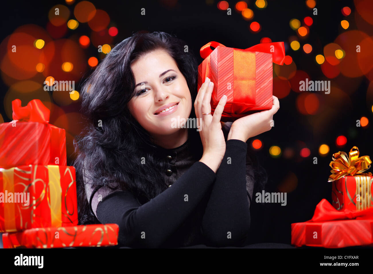 Cute woman with presents at night Stock Photo - Alamy