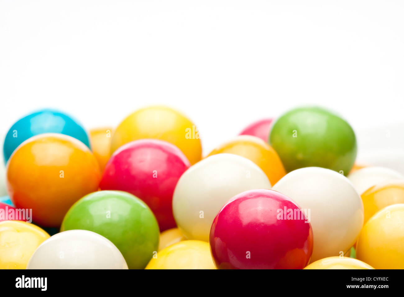 many colored gumballs on a white background Stock Photo - Alamy