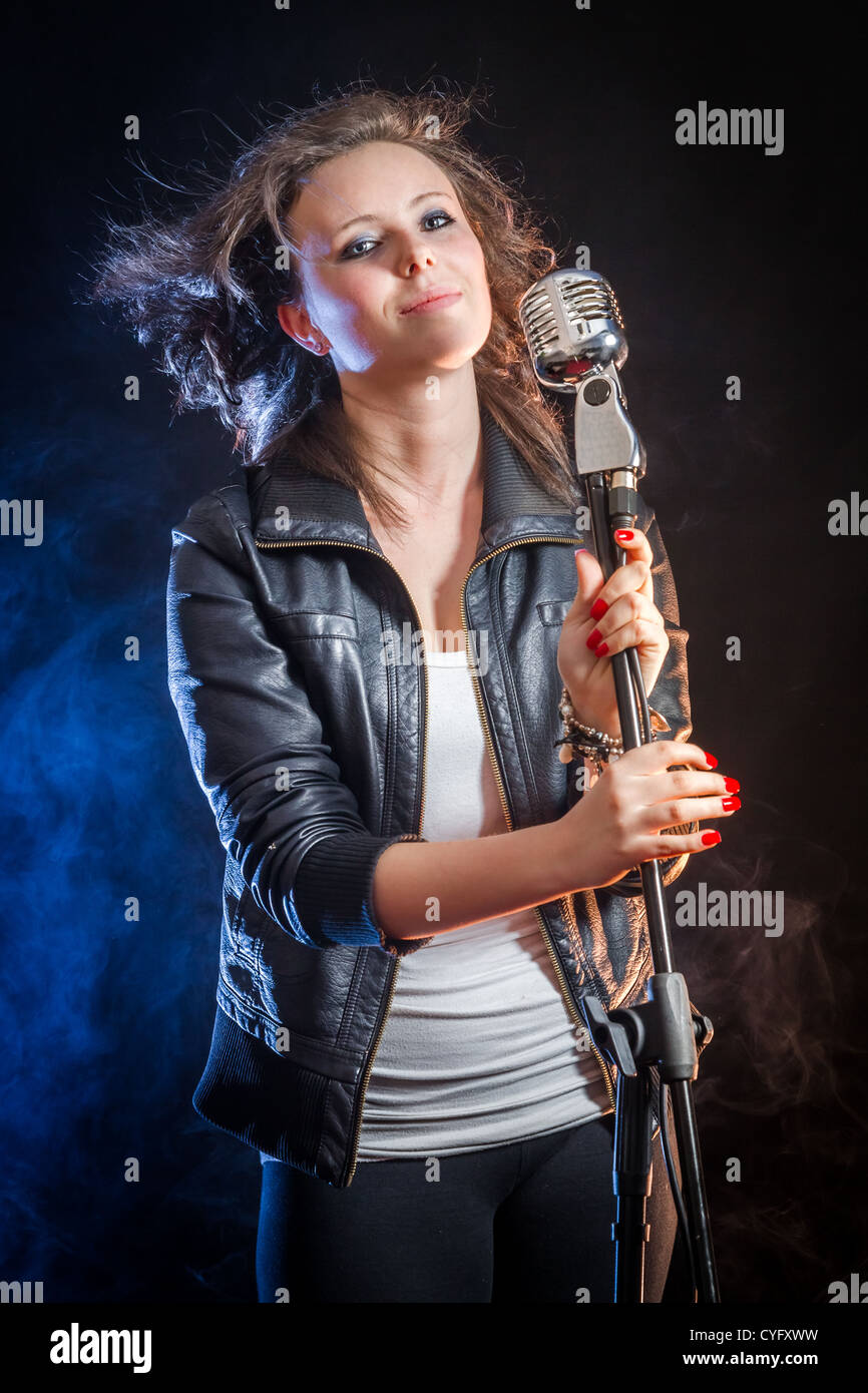 Beautiful young woman as a singer Stock Photo - Alamy