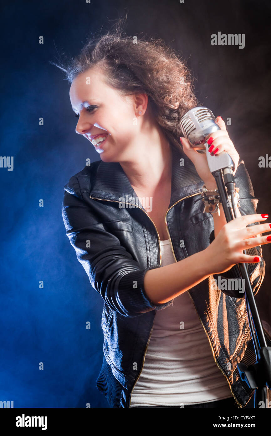 Laughing young singer on the stage Stock Photo - Alamy