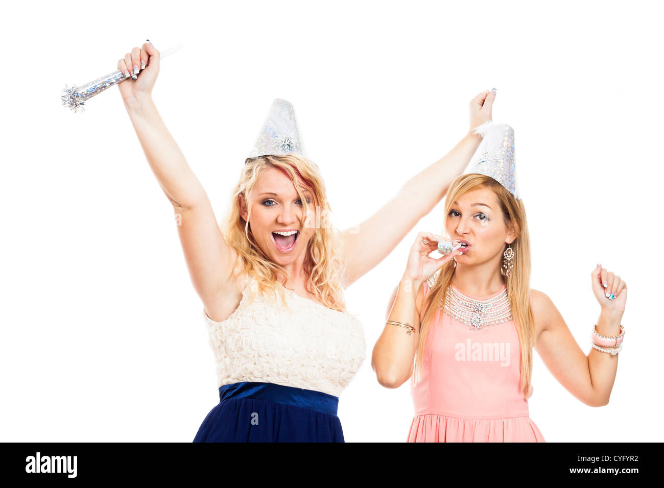 Two young ecstatic women celebrating party, isolated on white ...