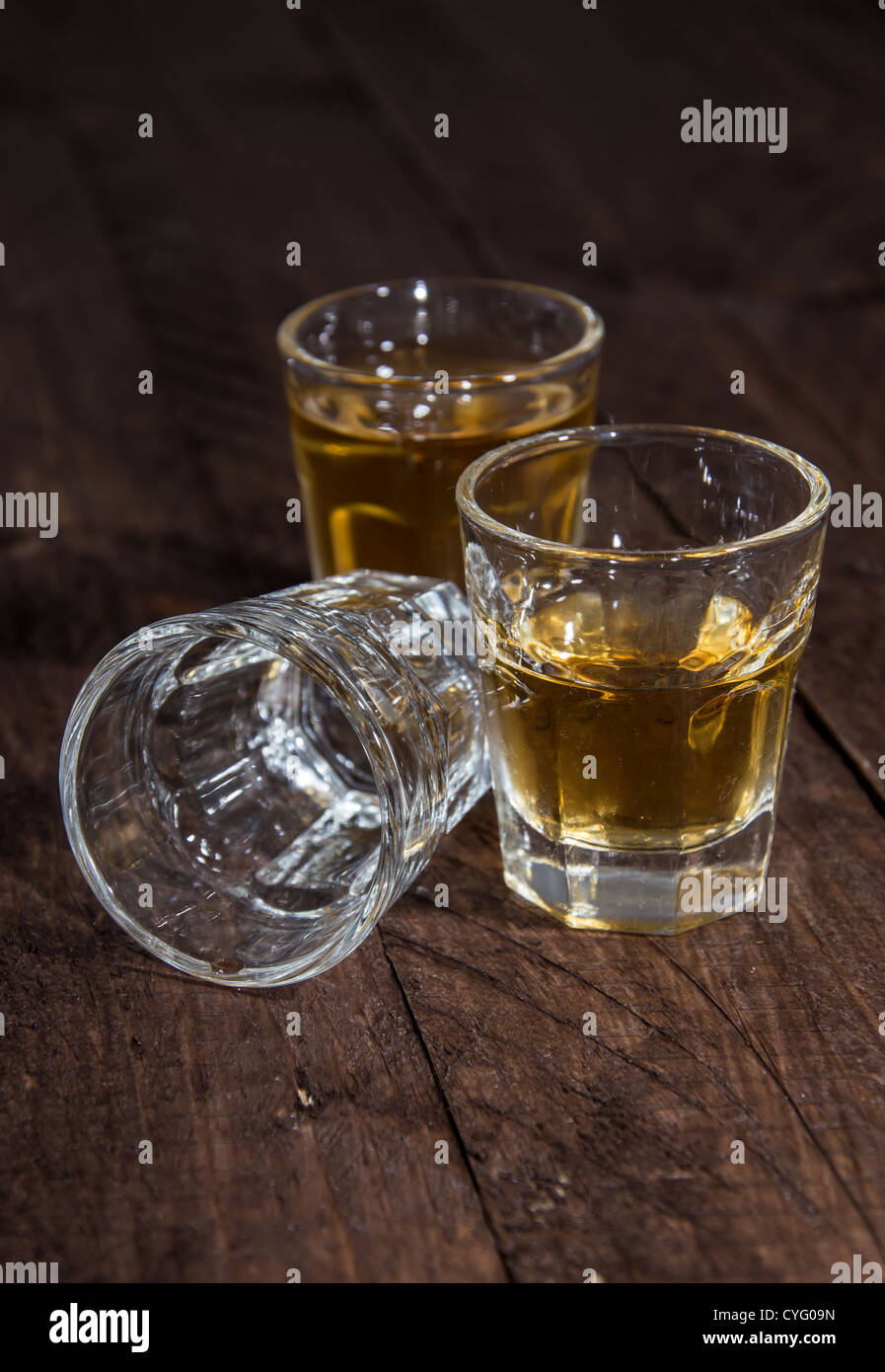 Three Glasses of Rum on wooden background Stock Photo - Alamy