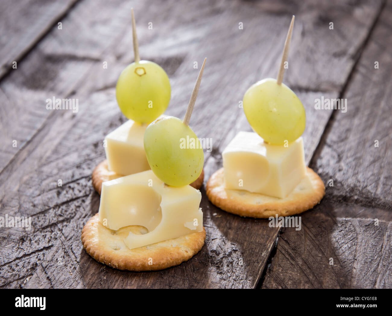 Pieces of Cheese on a Cracker topped with a Grape Stock Photo - Alamy