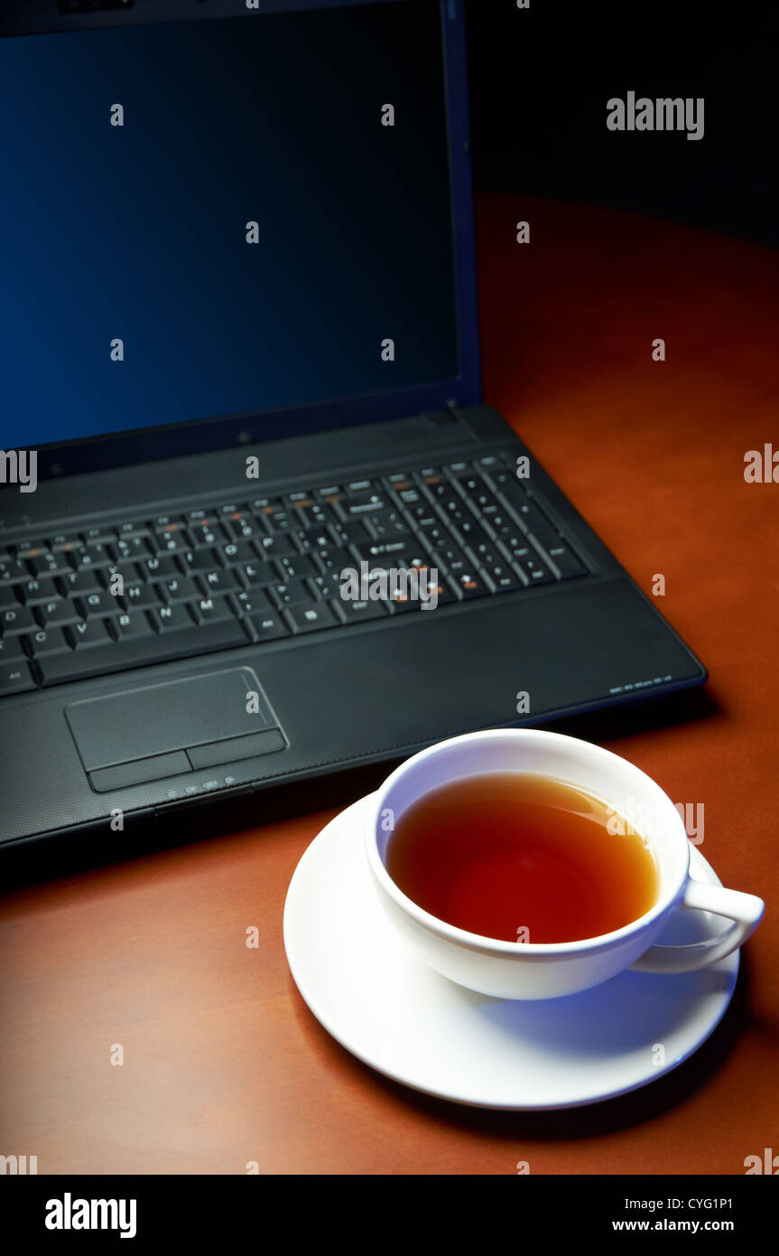 Laptop and a cup of tea Stock Photo - Alamy