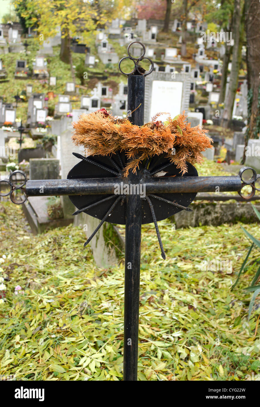 old black metal cross in the cemetery Stock Photo - Alamy