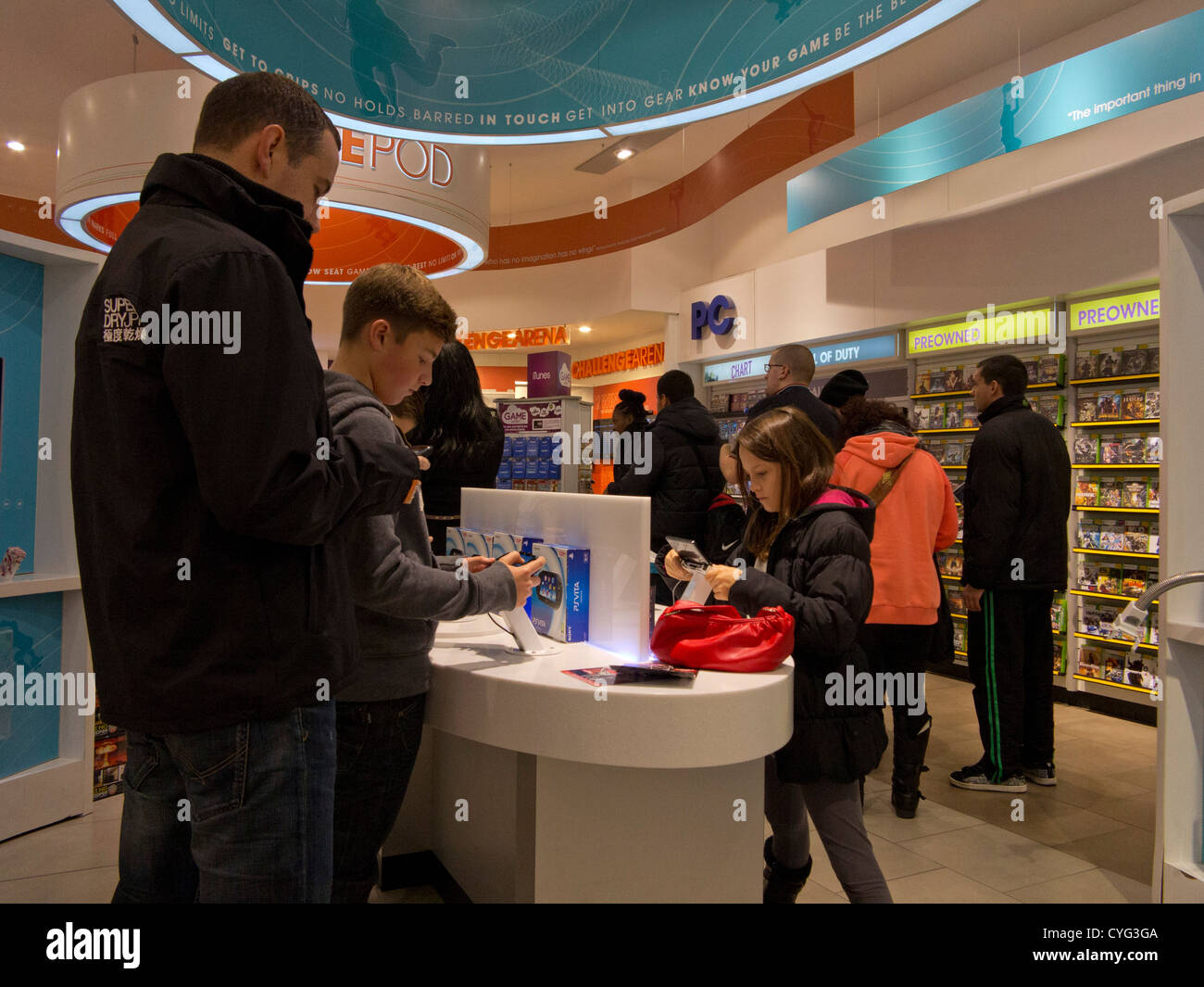 Parent and children at a Games shop in London, UK Stock Photo - Alamy