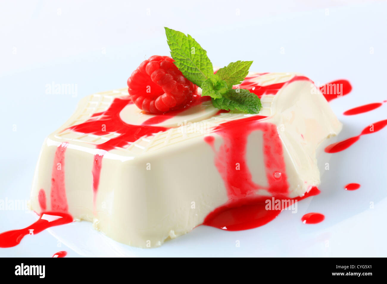 Panna cotta with fruit coulis and raspberry Stock Photo - Alamy
