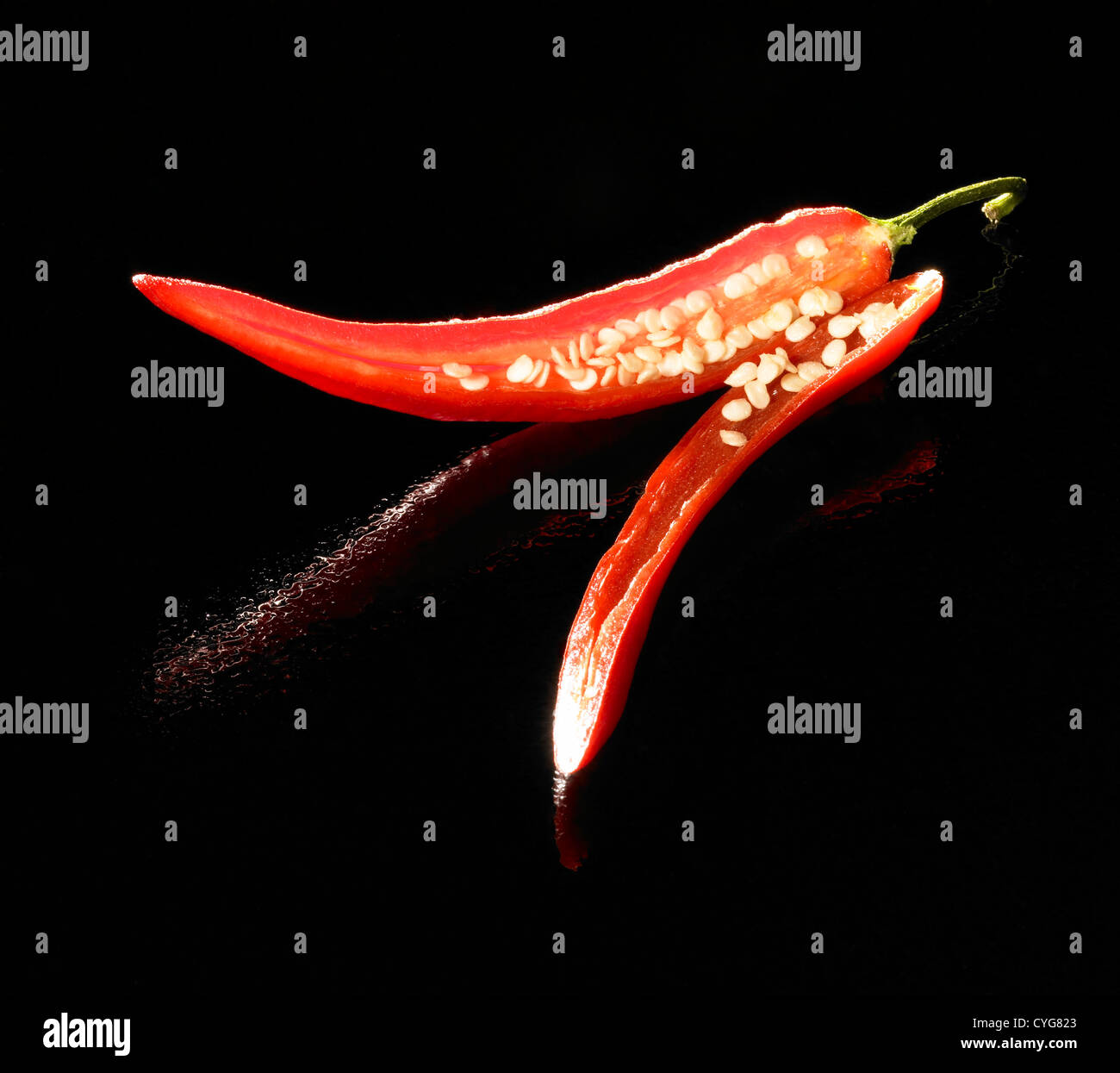 studio shot of a red sliced chili in black reflective back Stock Photo ...