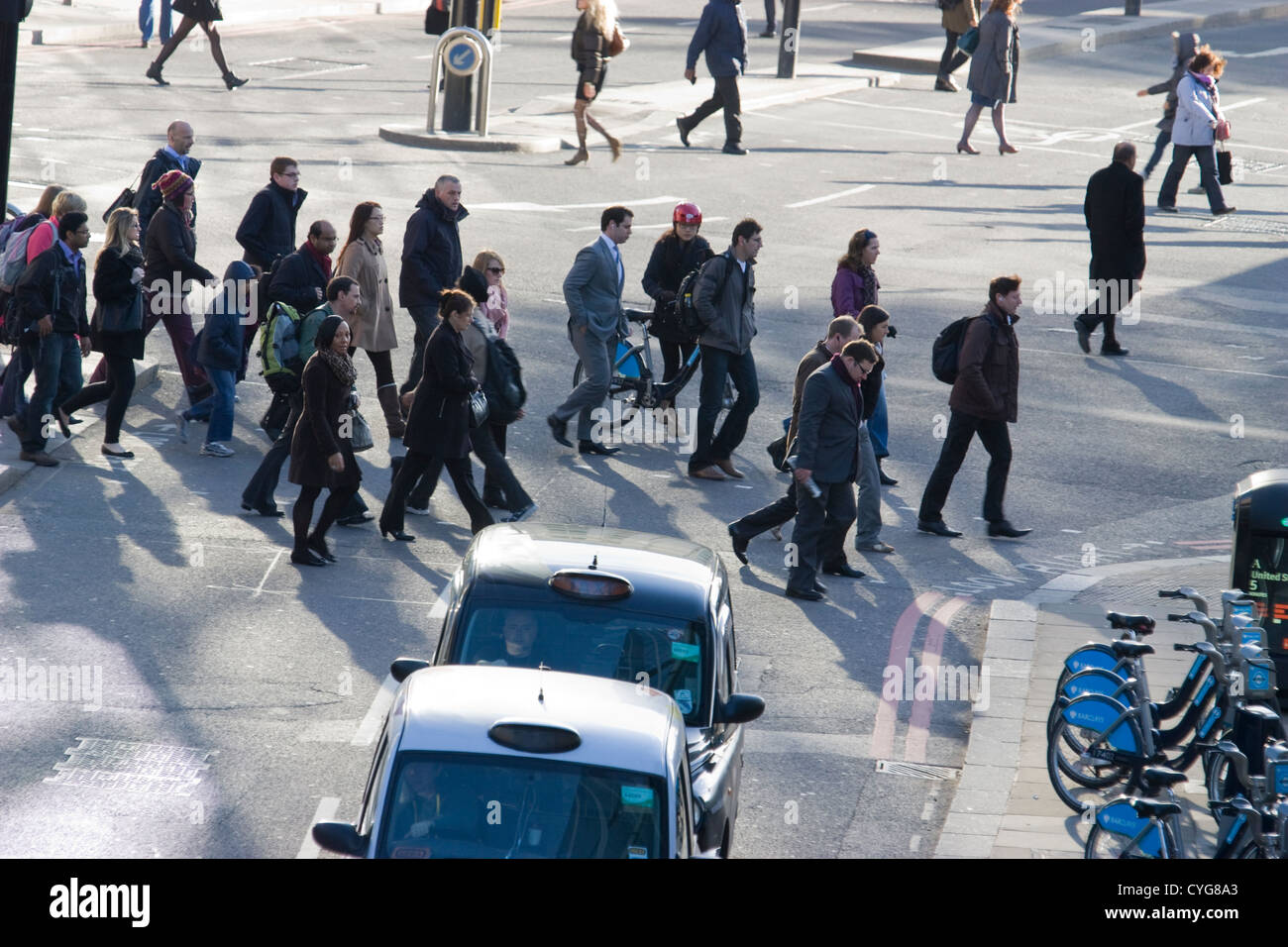 Morning commuters navigate a busy City of London street during rush ...