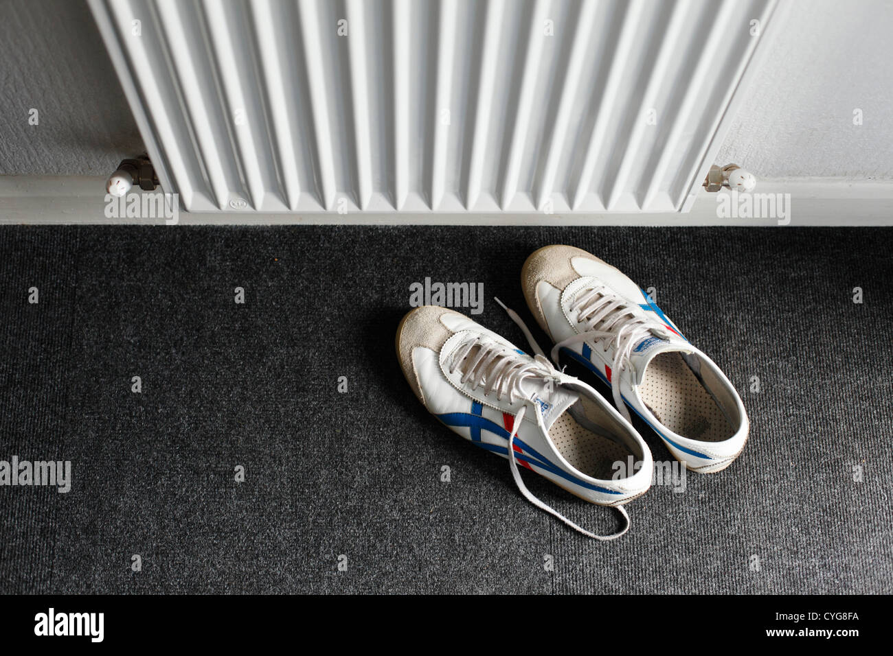 Trainers drying next to a radiator in an office in the U.K Stock Photo ...