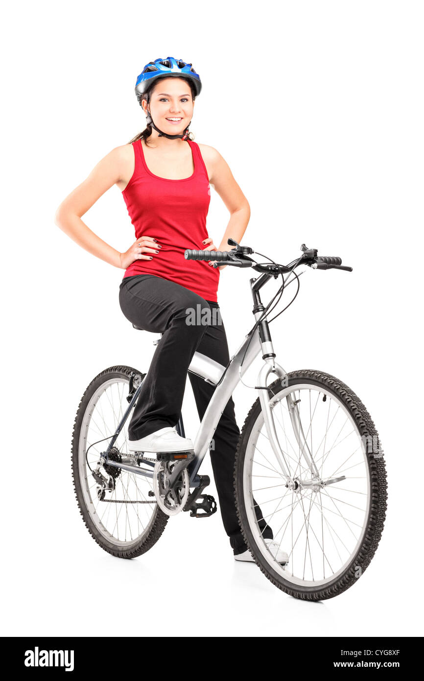 Full length portrait of a female bicyclist posing on a bicycle and ...
