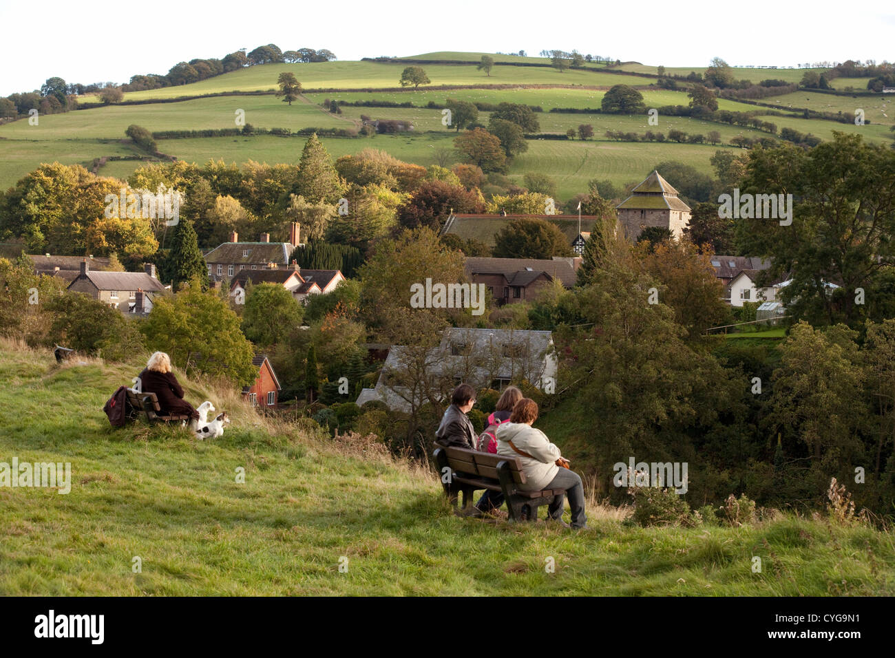 People looking at the view over the village of Clun, Shropshire UK ...