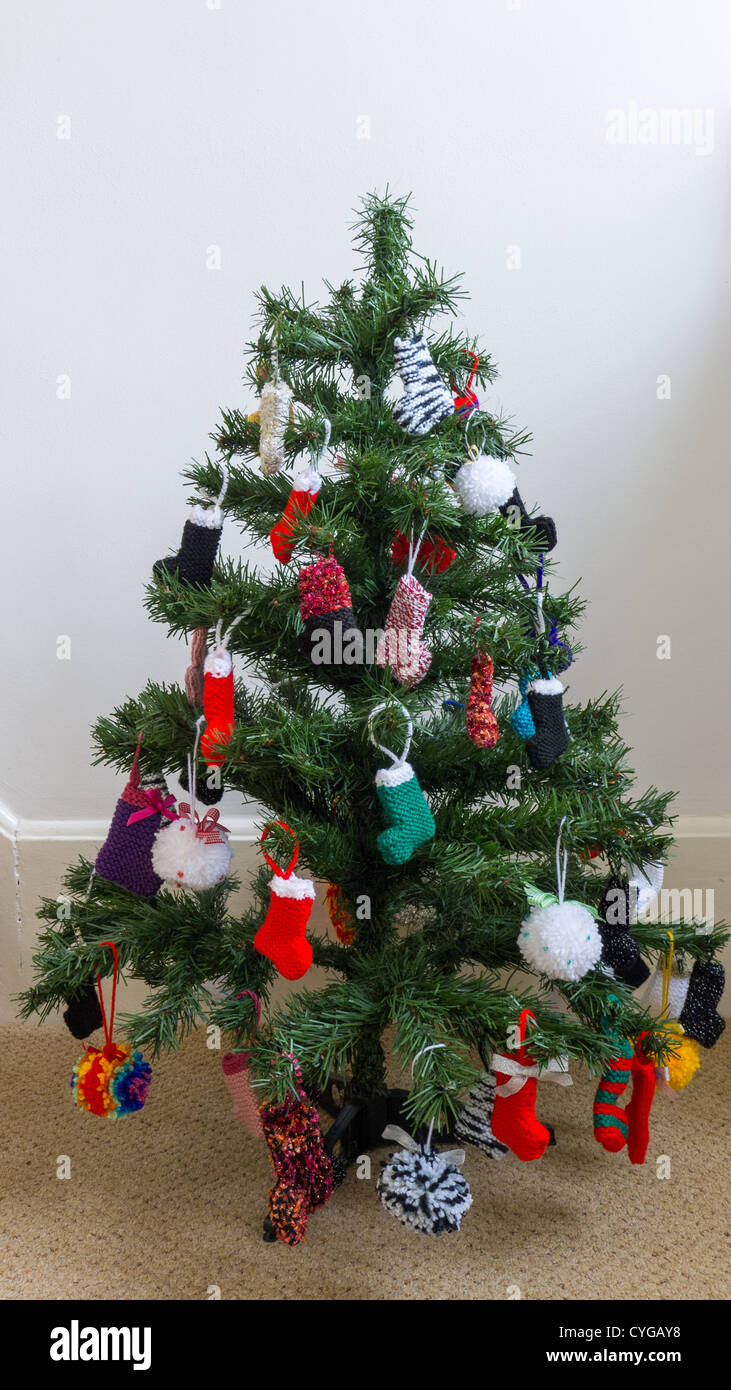 Artificial Christmas tree with knitted woollen decorations Stock Photo ...
