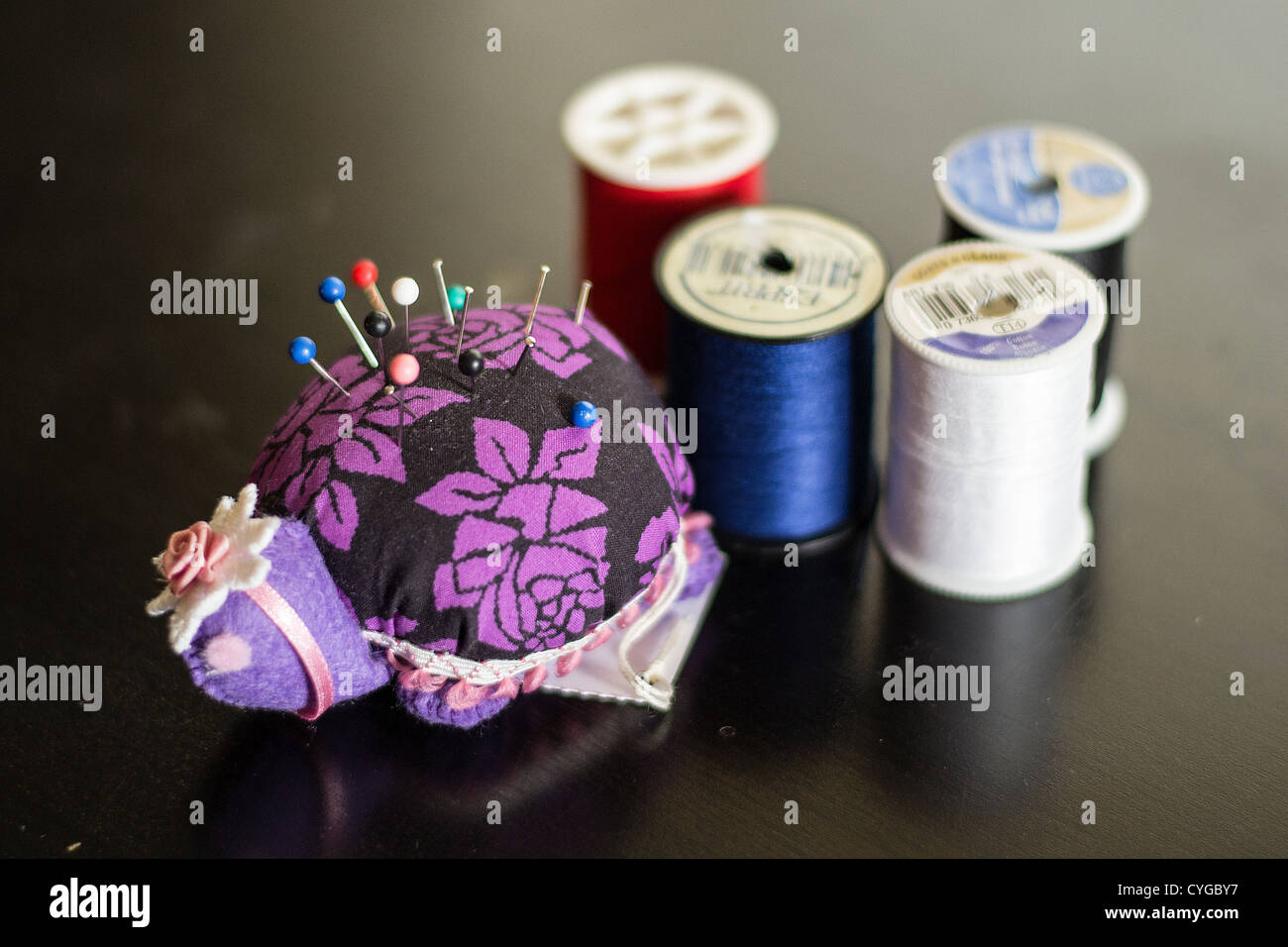 Sewing bobbins thread, seamstress pins needle Stock Photo - Alamy