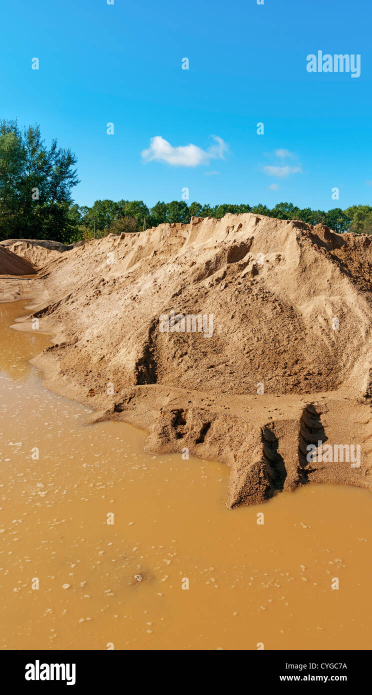 Sand dunes and muddy water under blue sky Stock Photo - Alamy